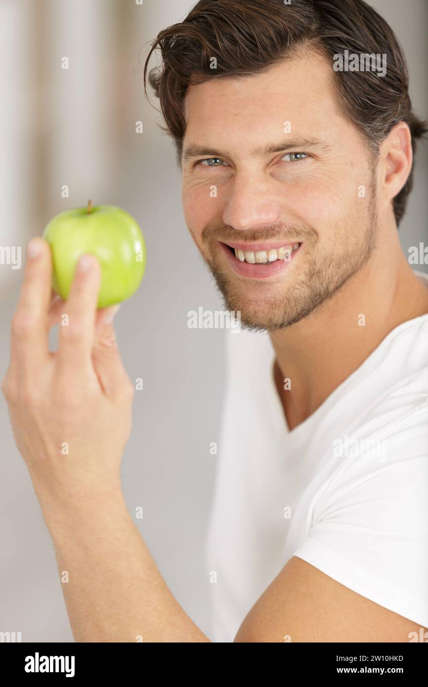 Young man eating tasty apple hi-res stock photography and images - Alamy