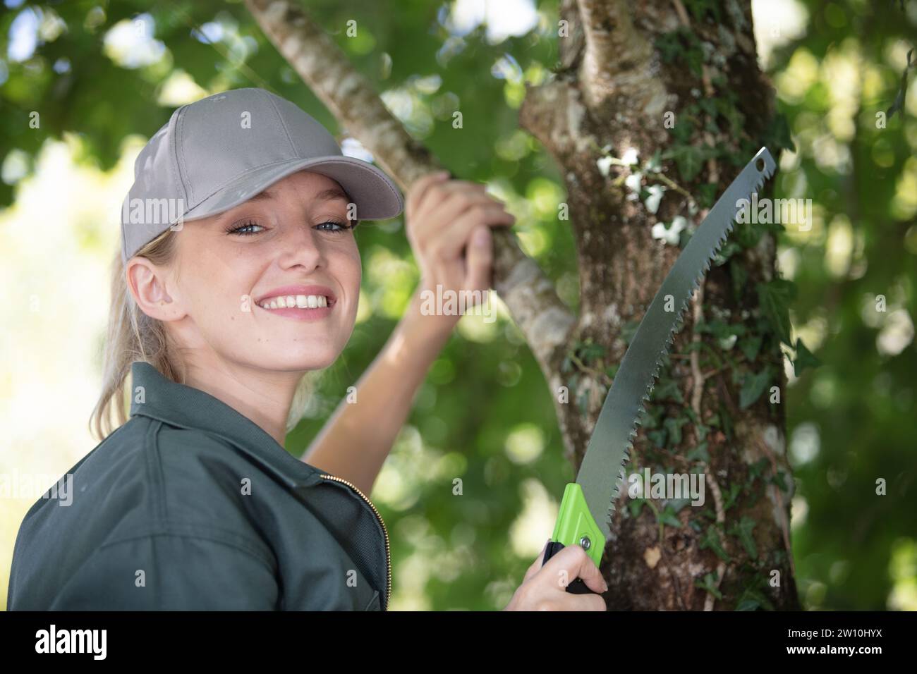 woman with rake and plant Stock Photo - Alamy