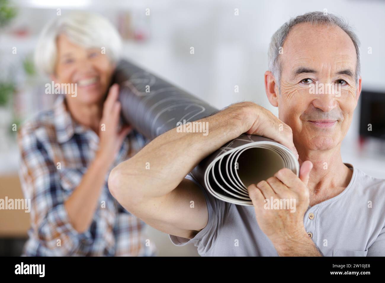 family lifting a heavy carpet Stock Photo - Alamy