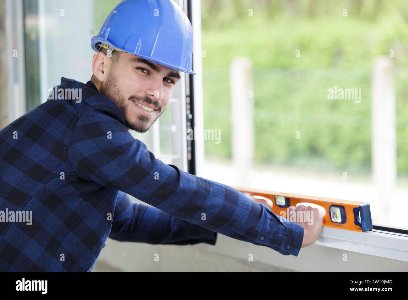 Young man using spirit level hi-res stock photography and images - Alamy