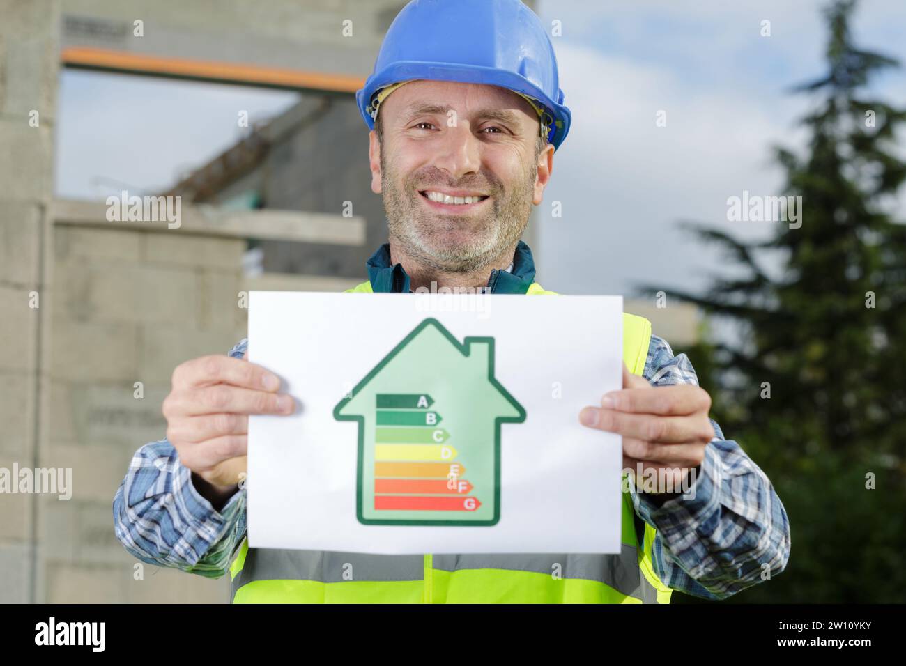 a construction worker holding an energy efficiency rating sign Stock ...