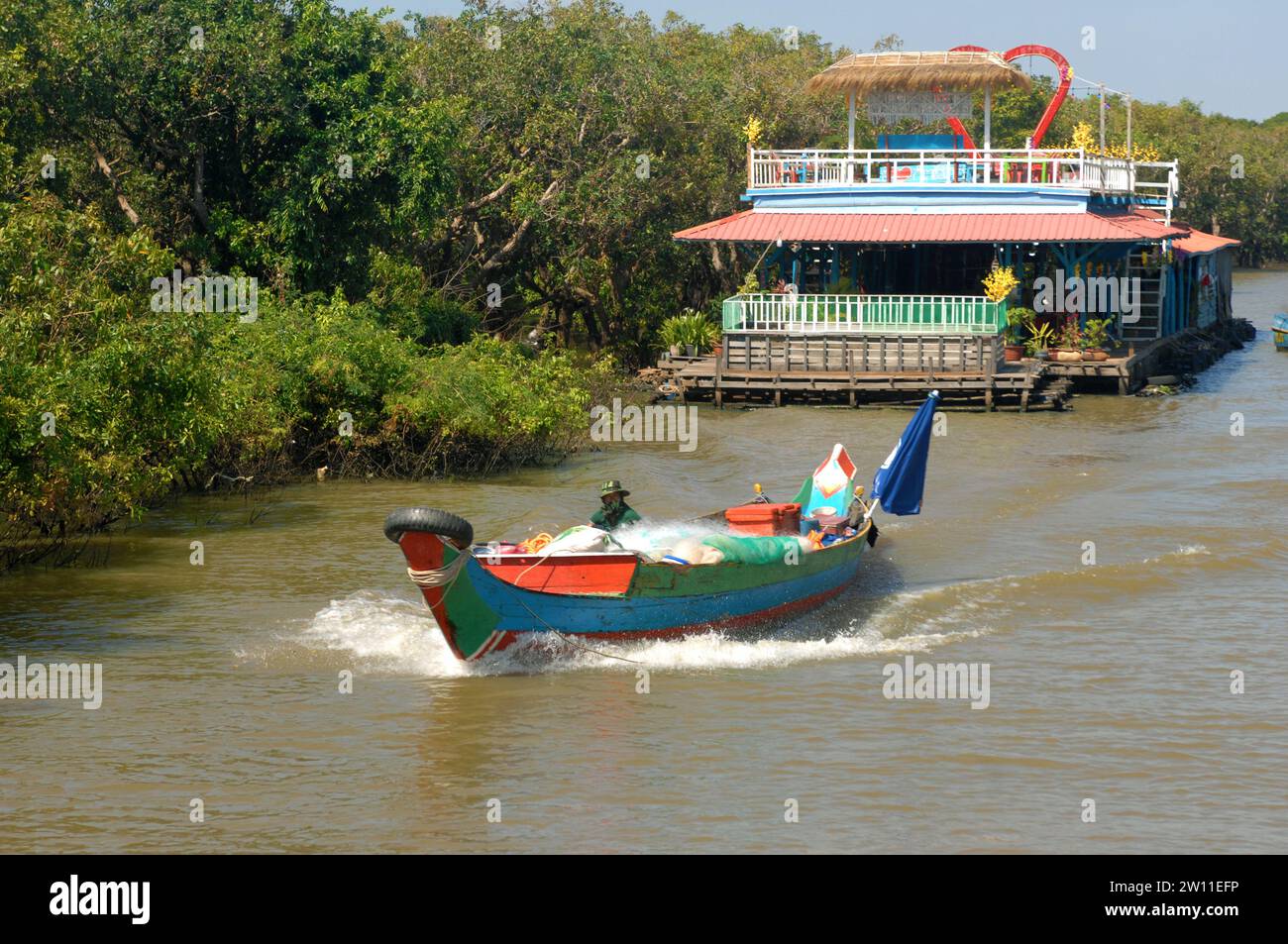 Boats moving along the waterways, Floating village Kampong Phluk in ...