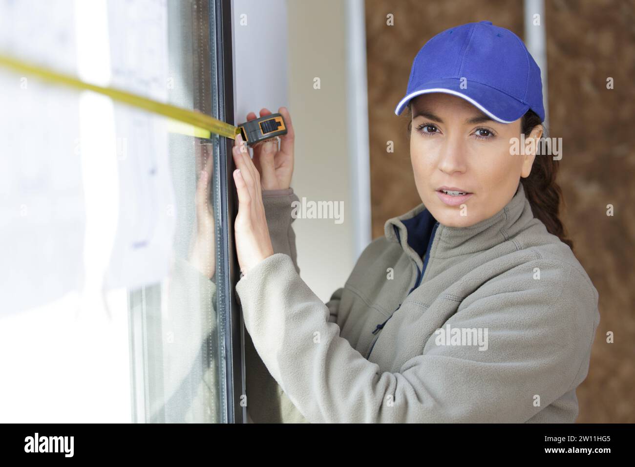 female worker measures a window Stock Photo - Alamy