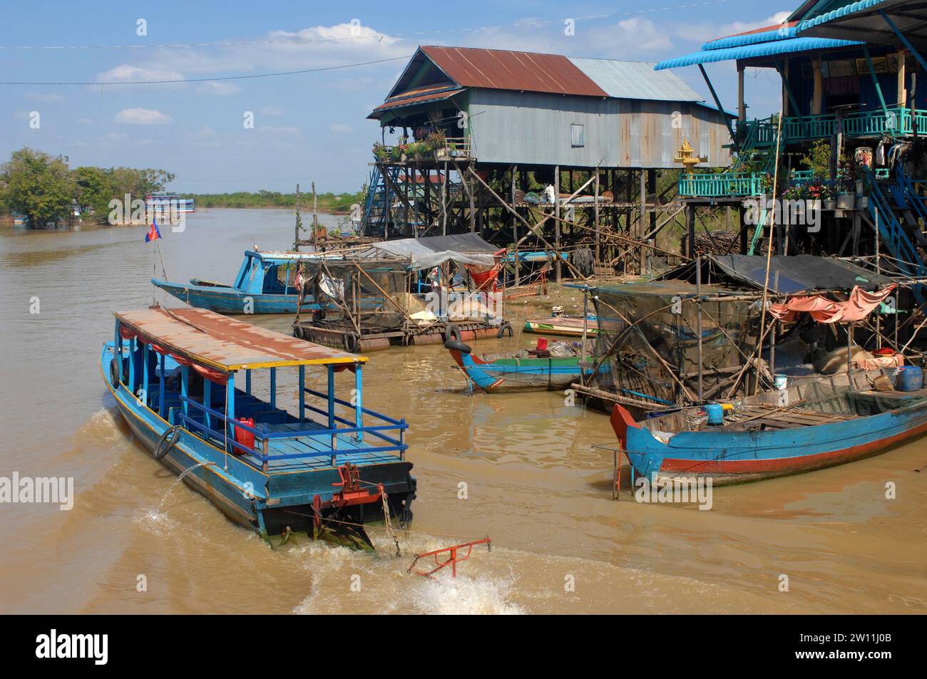 Boats moving along the waterways, Floating village Kampong Phluk in ...