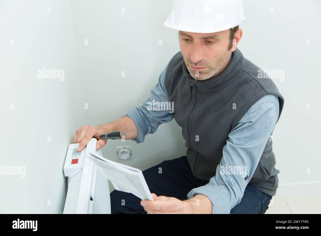 contractor following instructions to install and set up electric ...