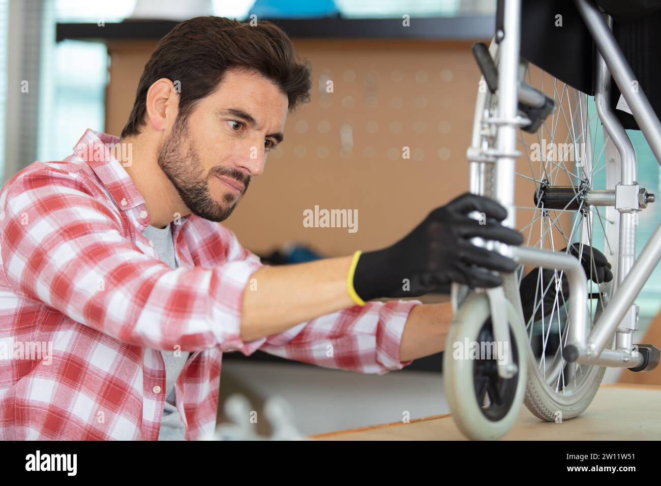 disabled man repairing a chair in his workplace Stock Photo - Alamy