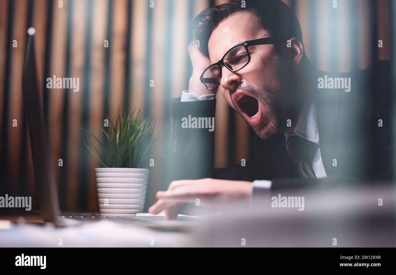 successful employee stretching and yawning during break in office after ...