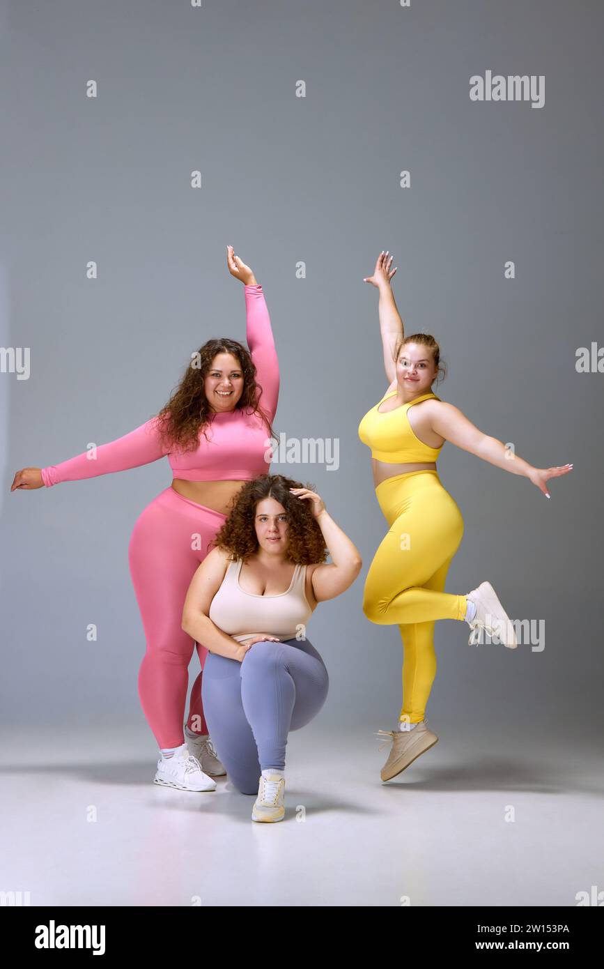 Happy, smiling, positive three young women with oversized bodies ...