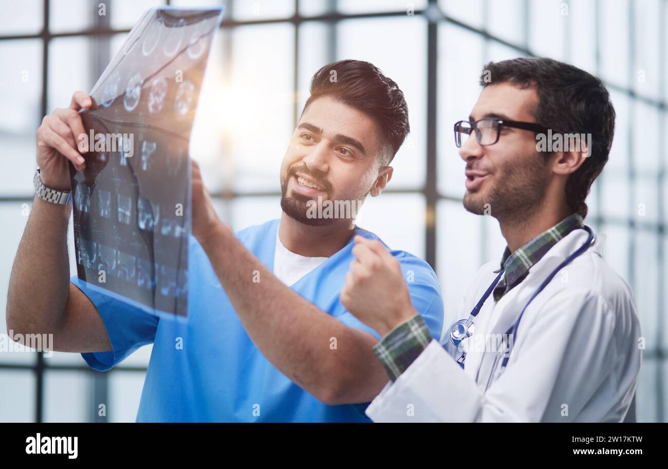 Two caucasian doctors view mri picture and discussing about it. Close ...