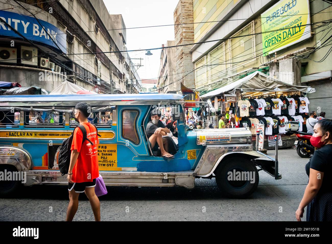 Classic jeepneys make their way through the congested market in the ...