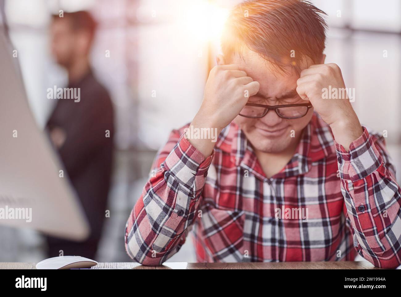 Portrait of young man propping up his head with his fist with Stock ...