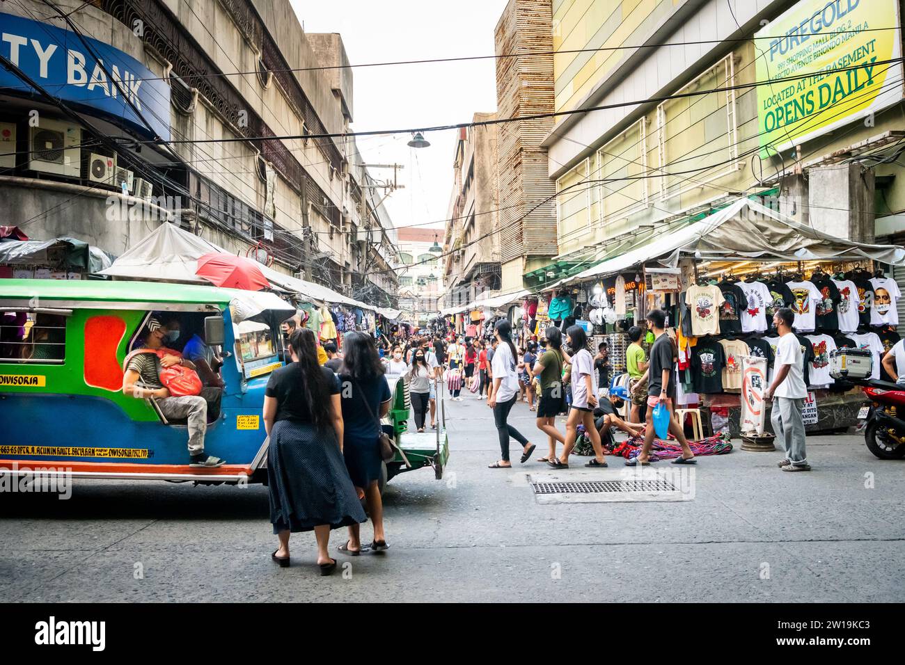 Classic jeepneys make their way through the congested market in the ...