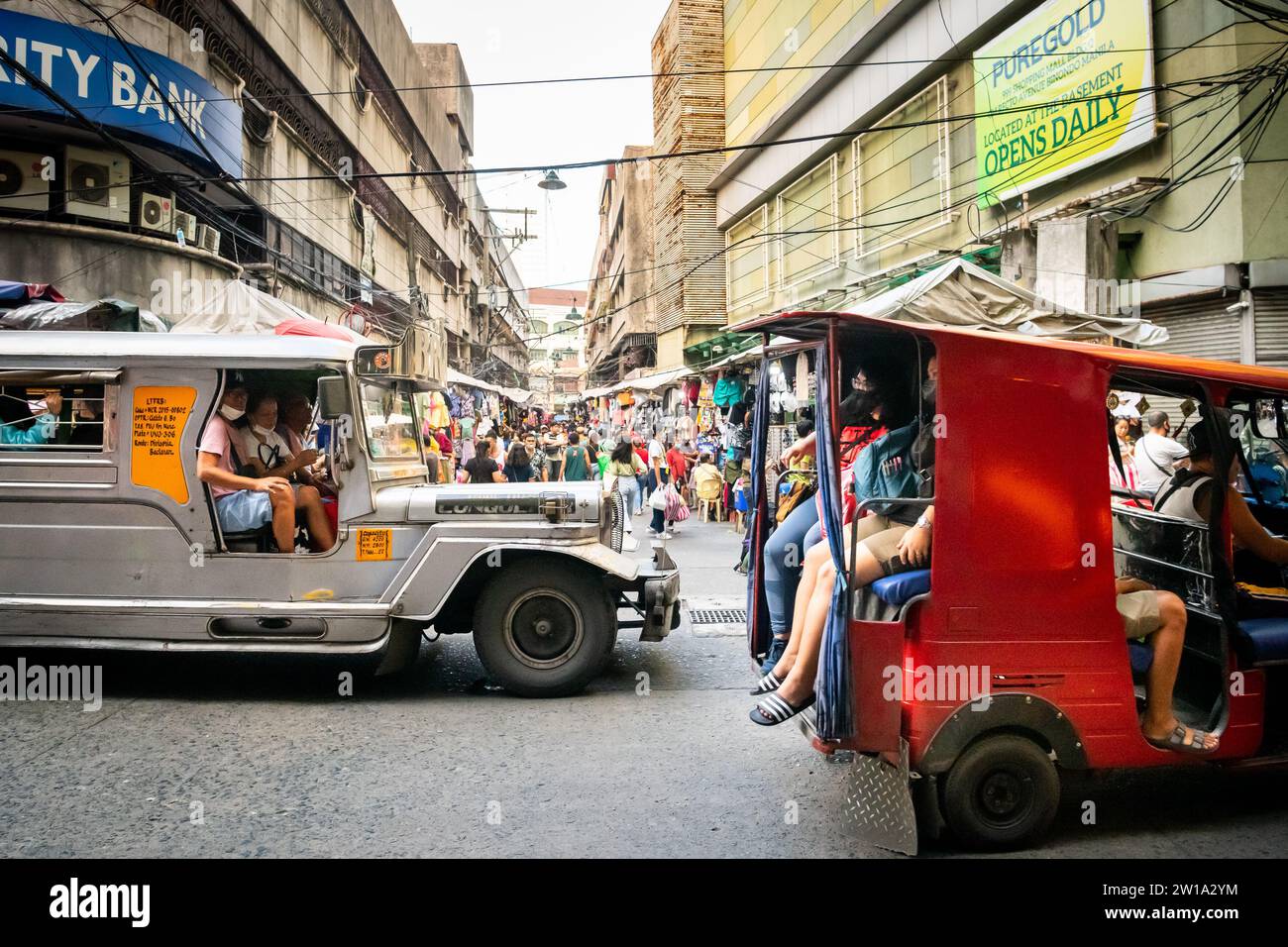 Classic jeepneys make their way through the congested market in the ...
