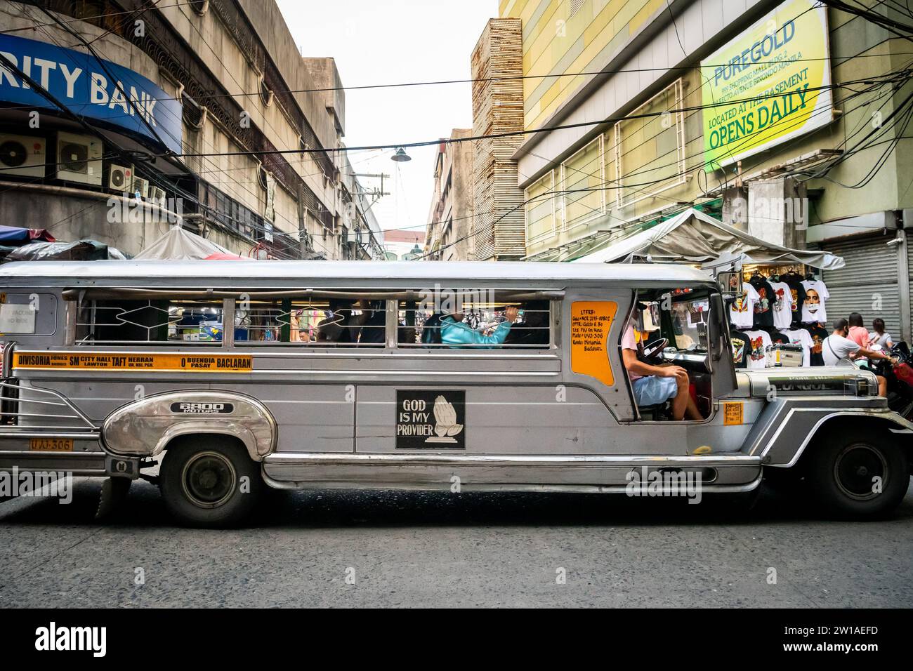 Classic jeepneys make their way through the congested market in the ...