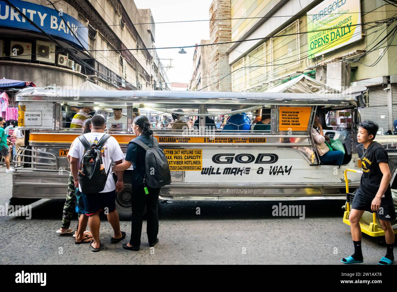 Classic jeepneys make their way through the congested market in the ...