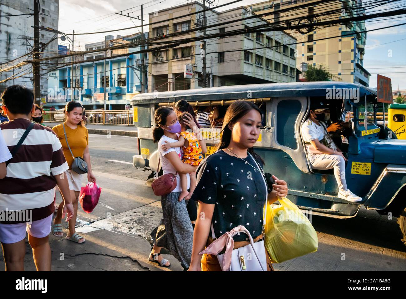 A typical busy street scene in Manila. Traffic is heavy with supplies ...