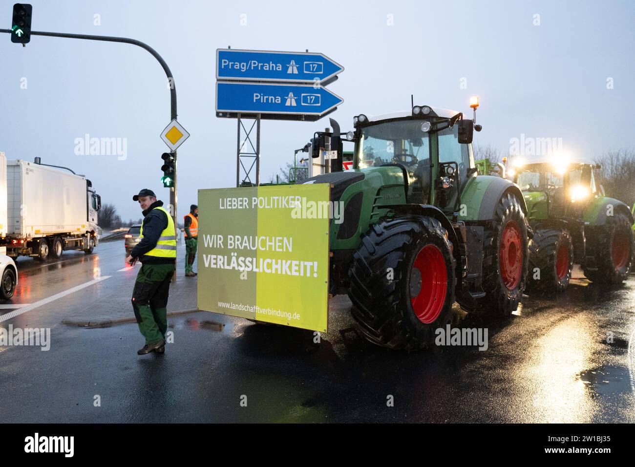 Dresden, Germany. 21st Dec, 2023. Farmers with tractors block a highway ...