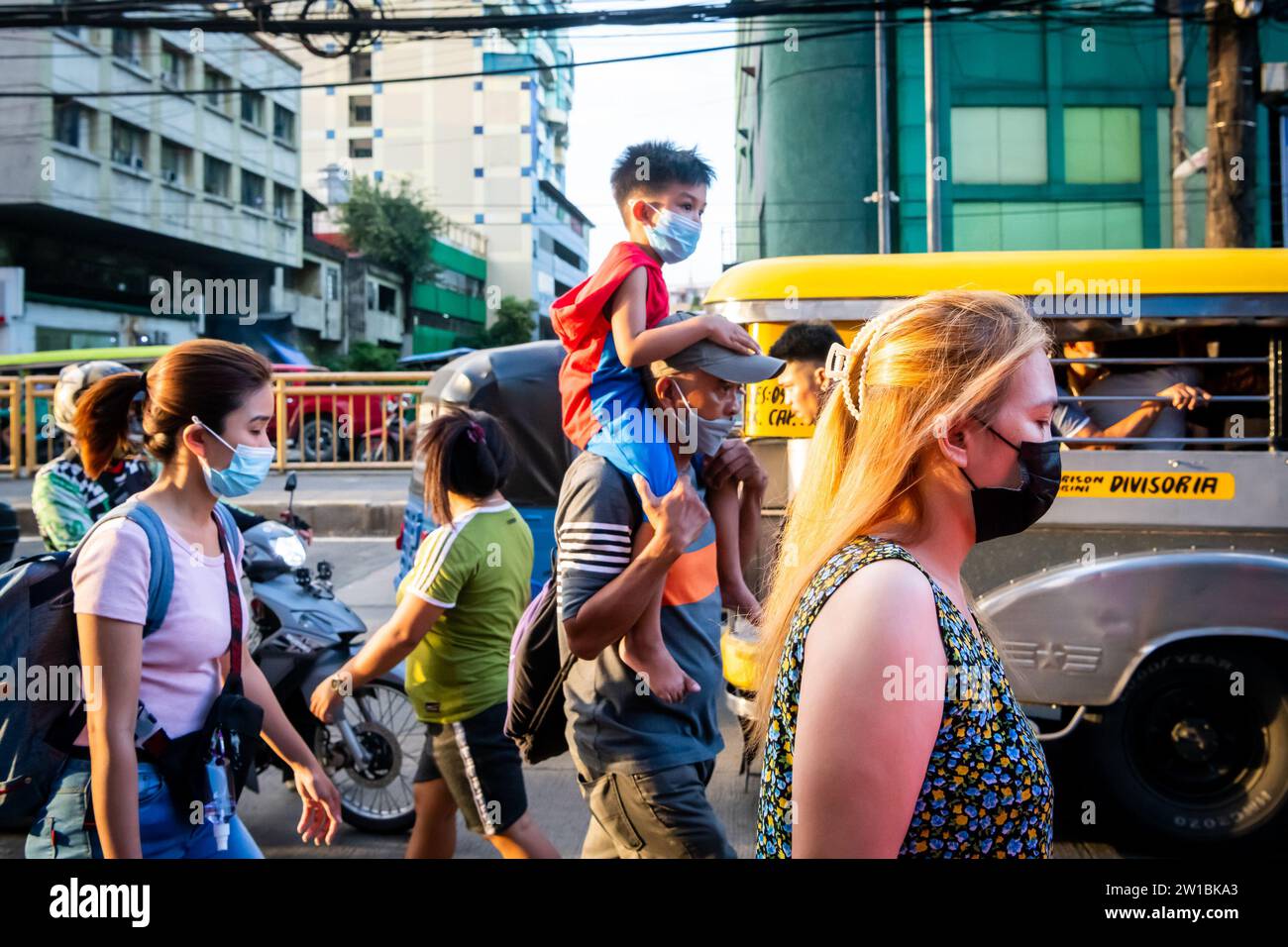 A typical busy street scene in Manila. Traffic is heavy with supplies being taken to the local ...
