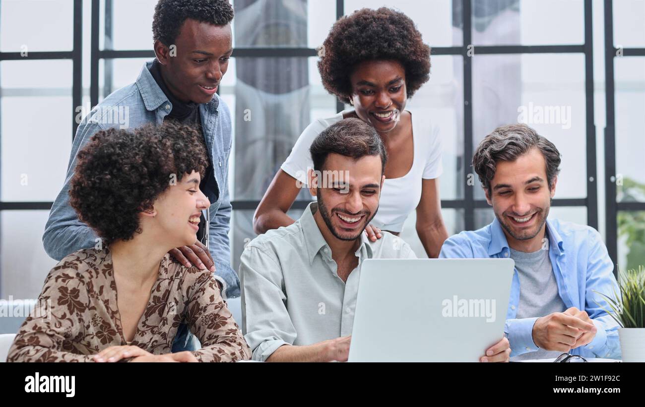 Employees working at computer together, discussing content Stock Photo ...
