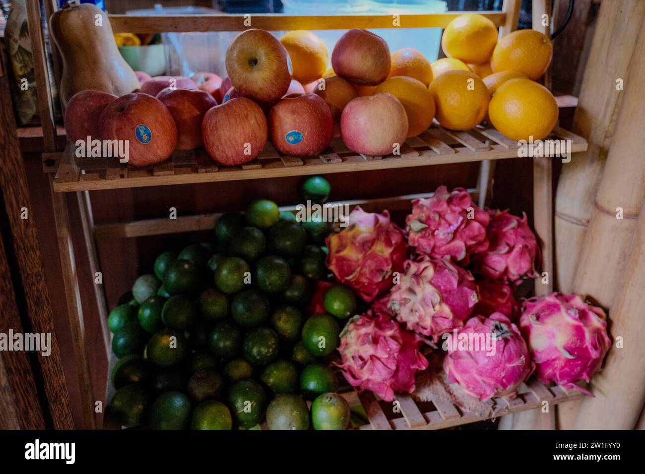 A delightful array of vibrant dragon fruit, green limettes, and ripe ...
