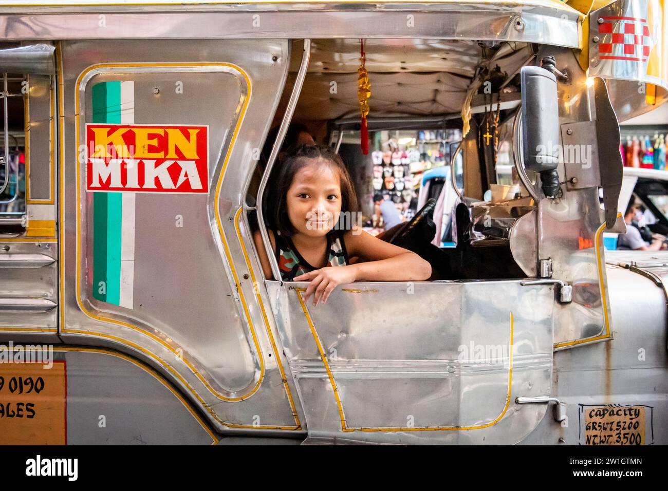 A pretty young Filipino girl smiles sat on a Manila jeepney Stock Photo ...