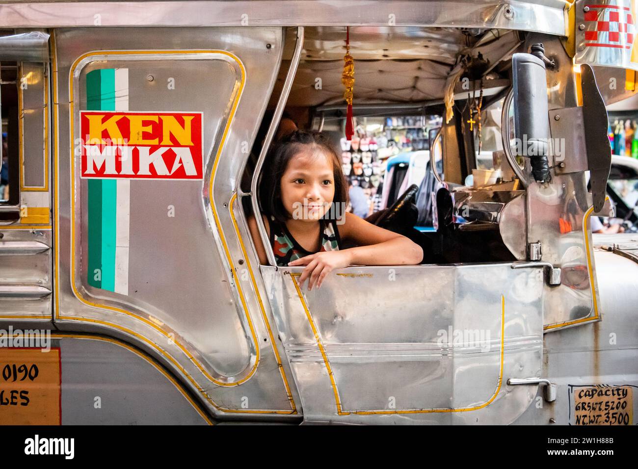 A pretty young Filipino girl smiles sat on a Manila jeepney Stock Photo ...