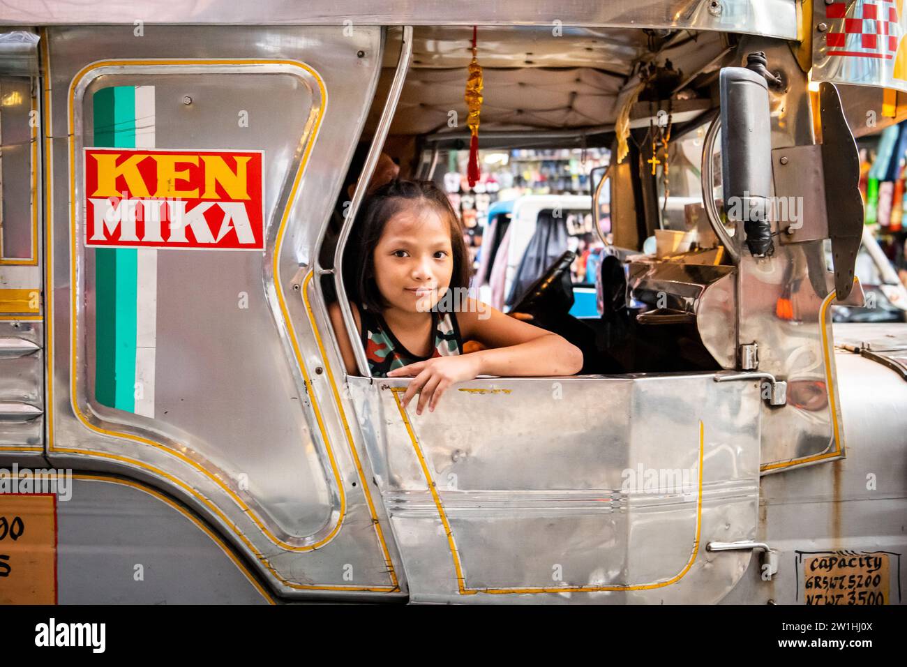 A pretty young Filipino girl smiles sat on a Manila jeepney Stock Photo ...