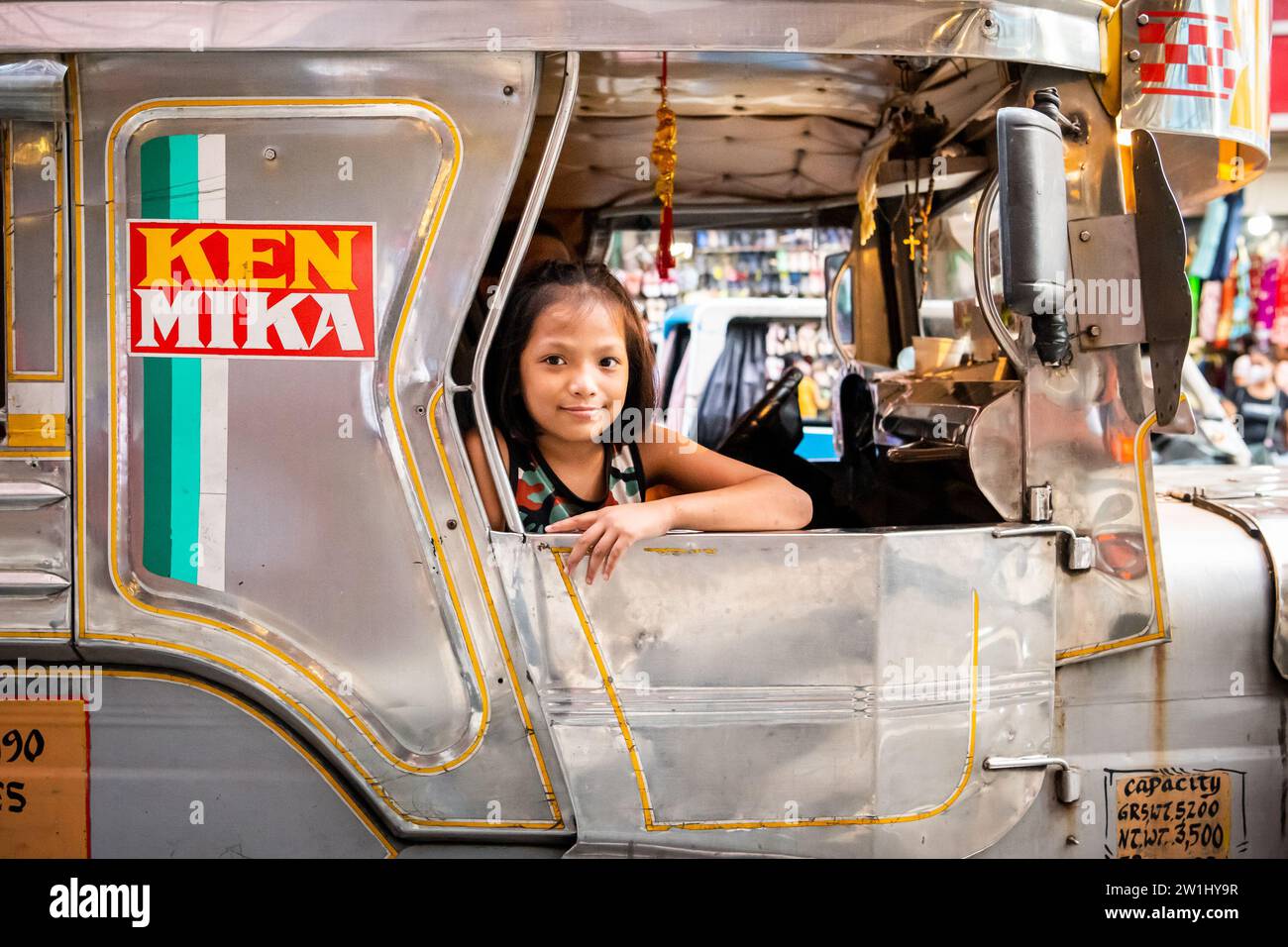 A pretty young Filipino girl smiles sat on a Manila jeepney Stock Photo ...