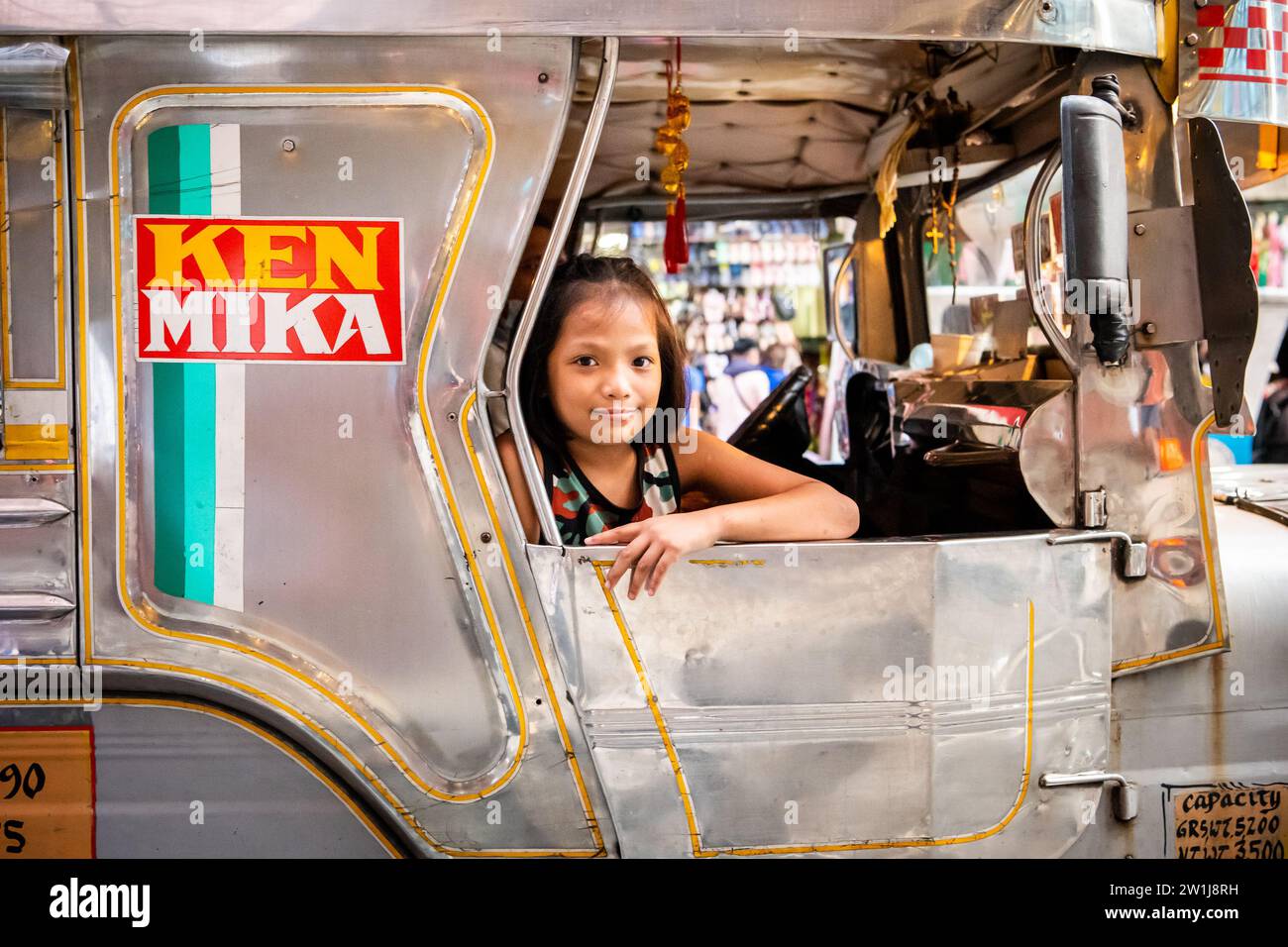 A pretty young Filipino girl smiles sat on a Manila jeepney Stock Photo ...