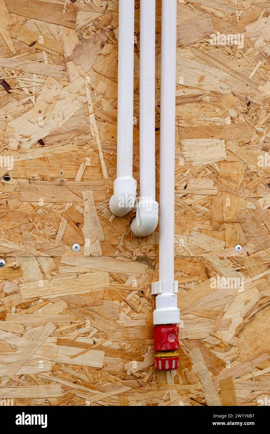 Water supply polypropylene pipes on a wooden wall surface. Installation ...