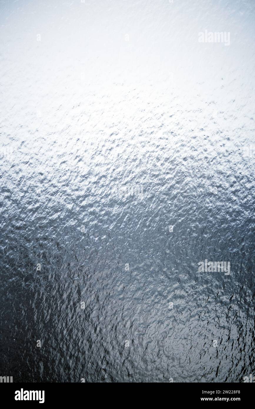Freezing rain on a window, ice on the windowpane. Frost ice patterns on ...