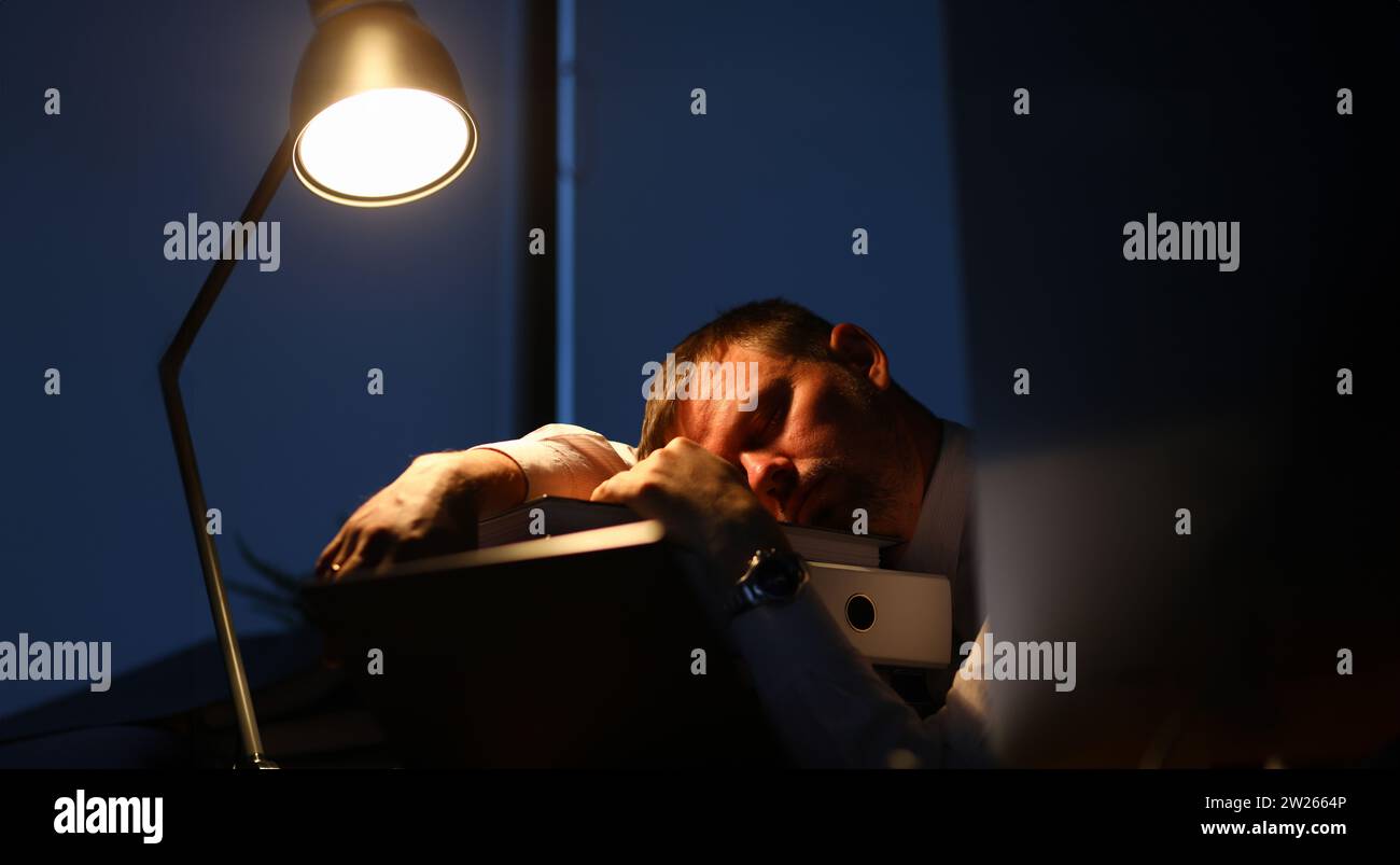 Man sleeping on office table evening time Stock Photo - Alamy