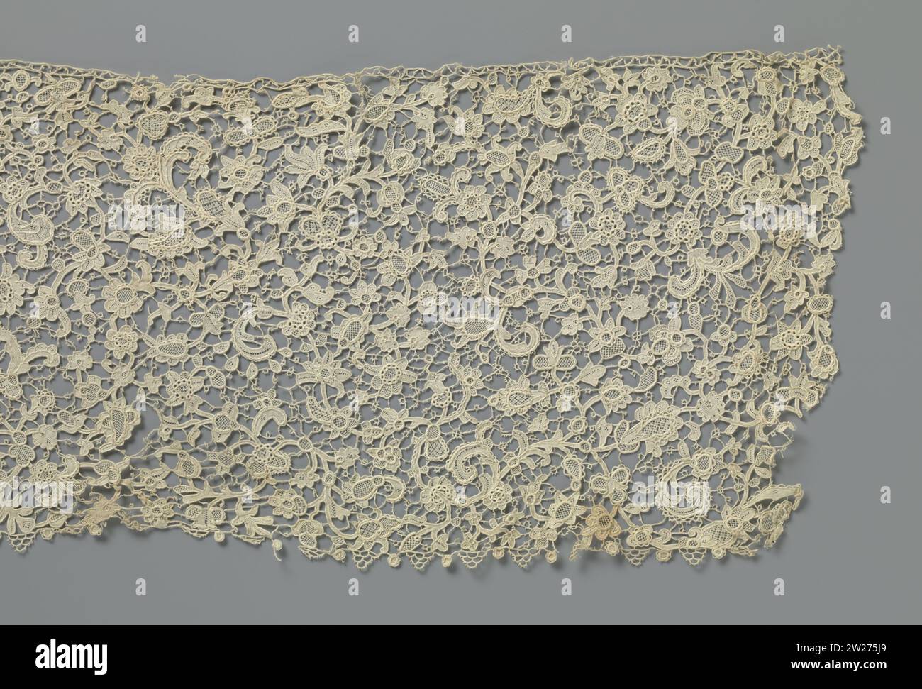 Strip of needle side with slanted rosette flower between three curling ...