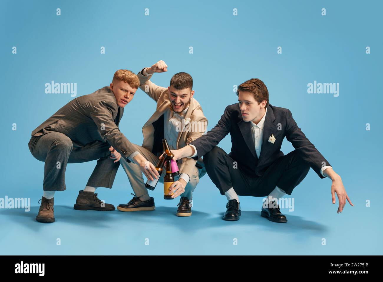 Men in stylish suits, friends attending party, drinking beer against ...