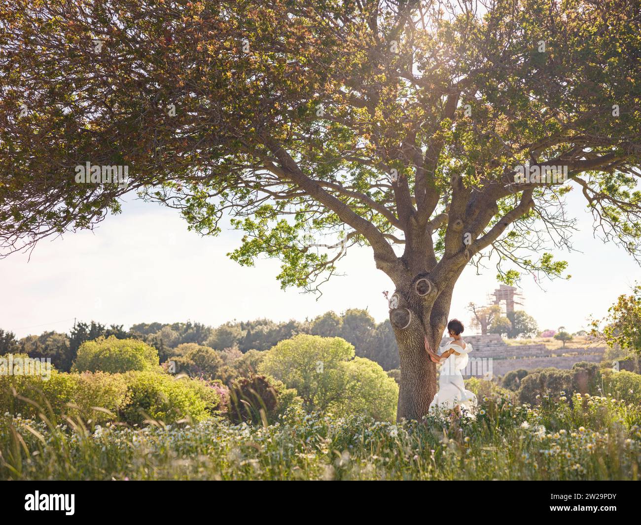 Beautiful Asian young woman in white dress outdoor. Acropolis of Rhodes ...