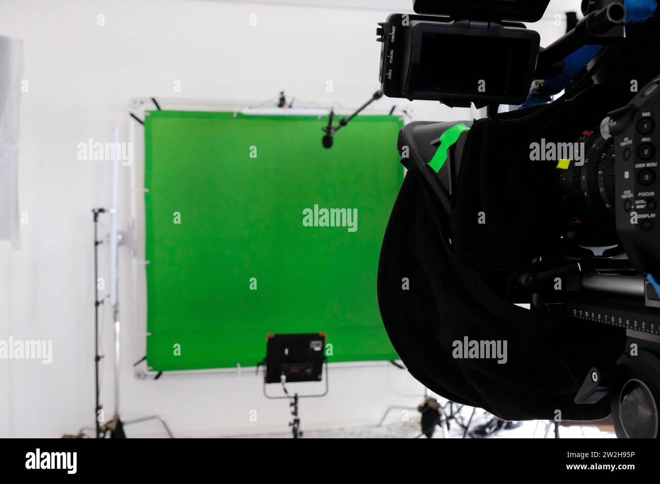 Setup in a TV studio with green screen, lights, and camera Stock Photo ...