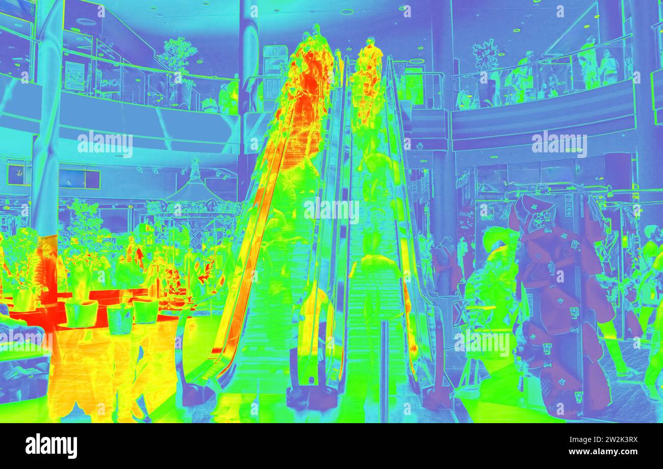 Infrared view of fast moving people in a shopping area - motion ...