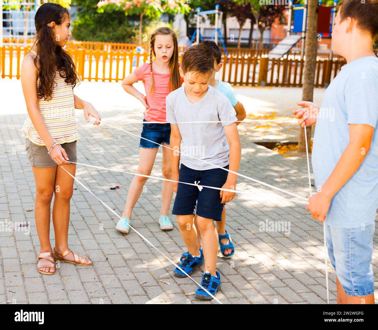 Children's games. The boy carefully walks along the tangled rope Stock ...