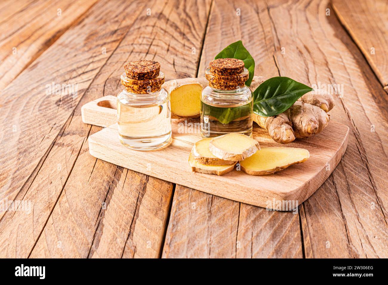 Natural homemade ginger root oil in two glass bottles with a cork cap ...