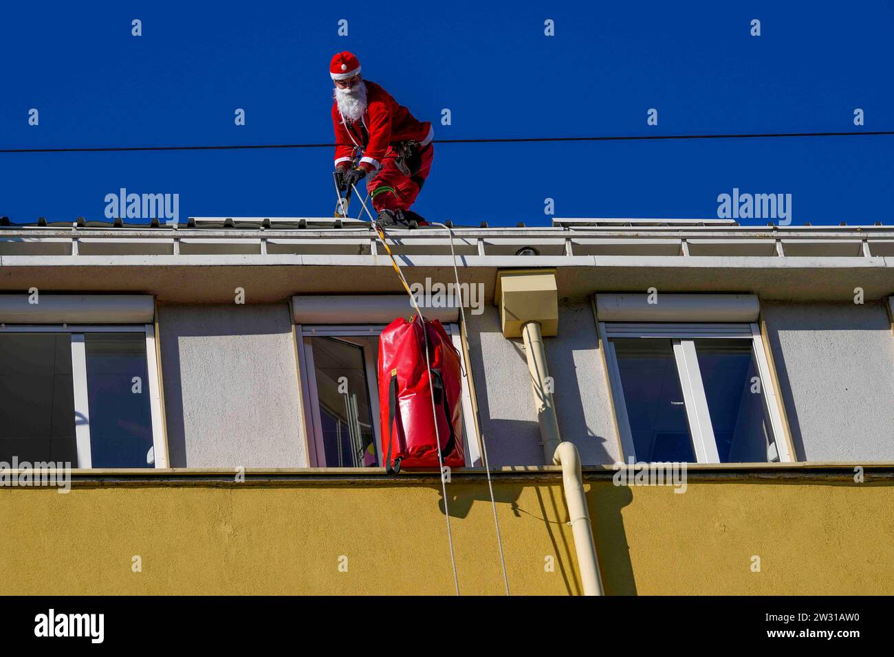 A Serbian Mountain Rescue Service member dressed as Santa Claus ...