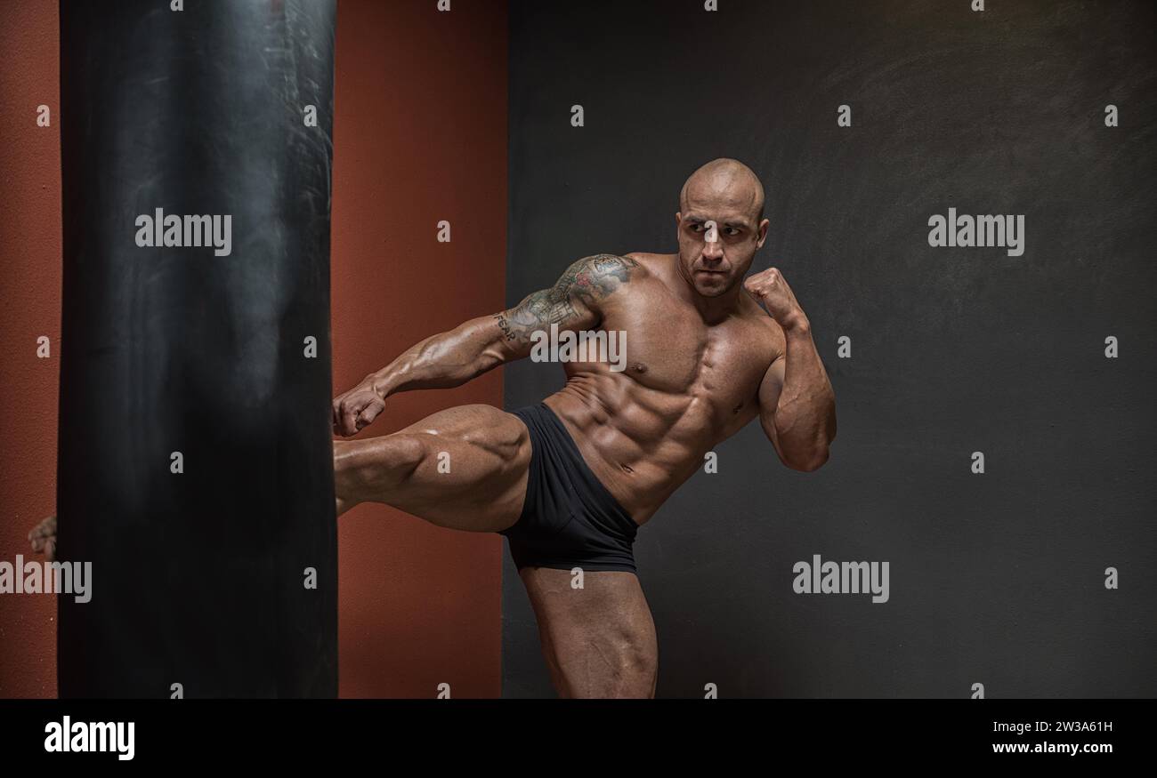 Fighter mixed martial arts training in the gym without gloves in short ...