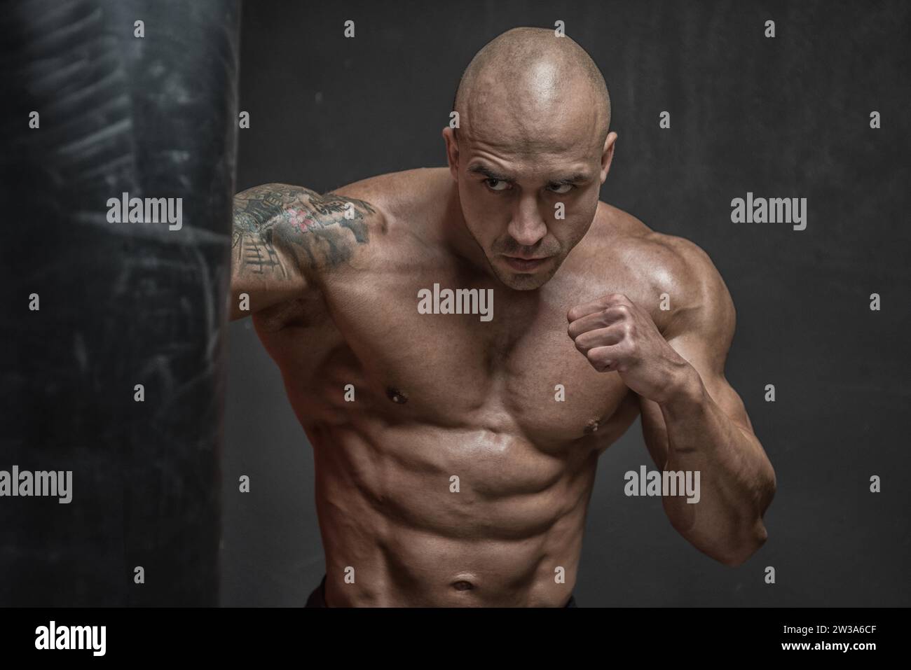 Fighter mixed martial arts training in the gym without gloves in short ...