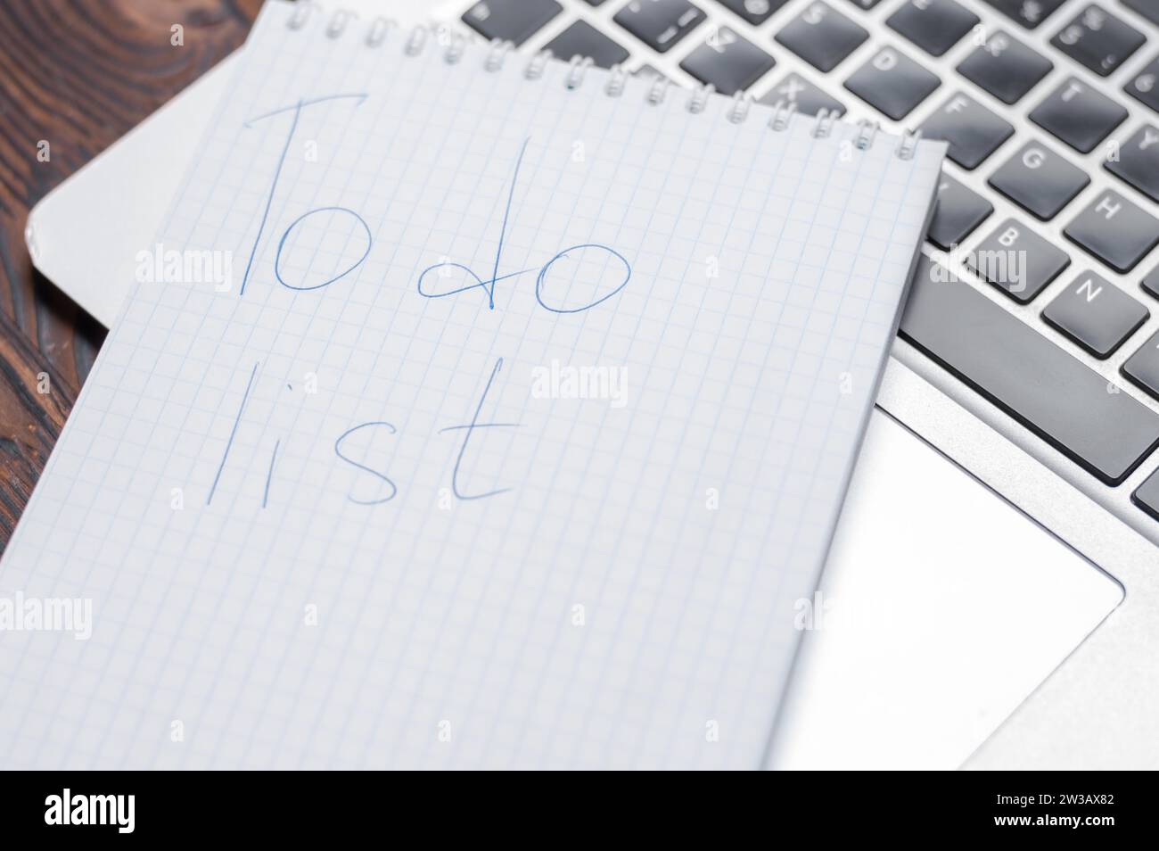 Image of a notebook with a pen lying on a laptop. Business planning ...