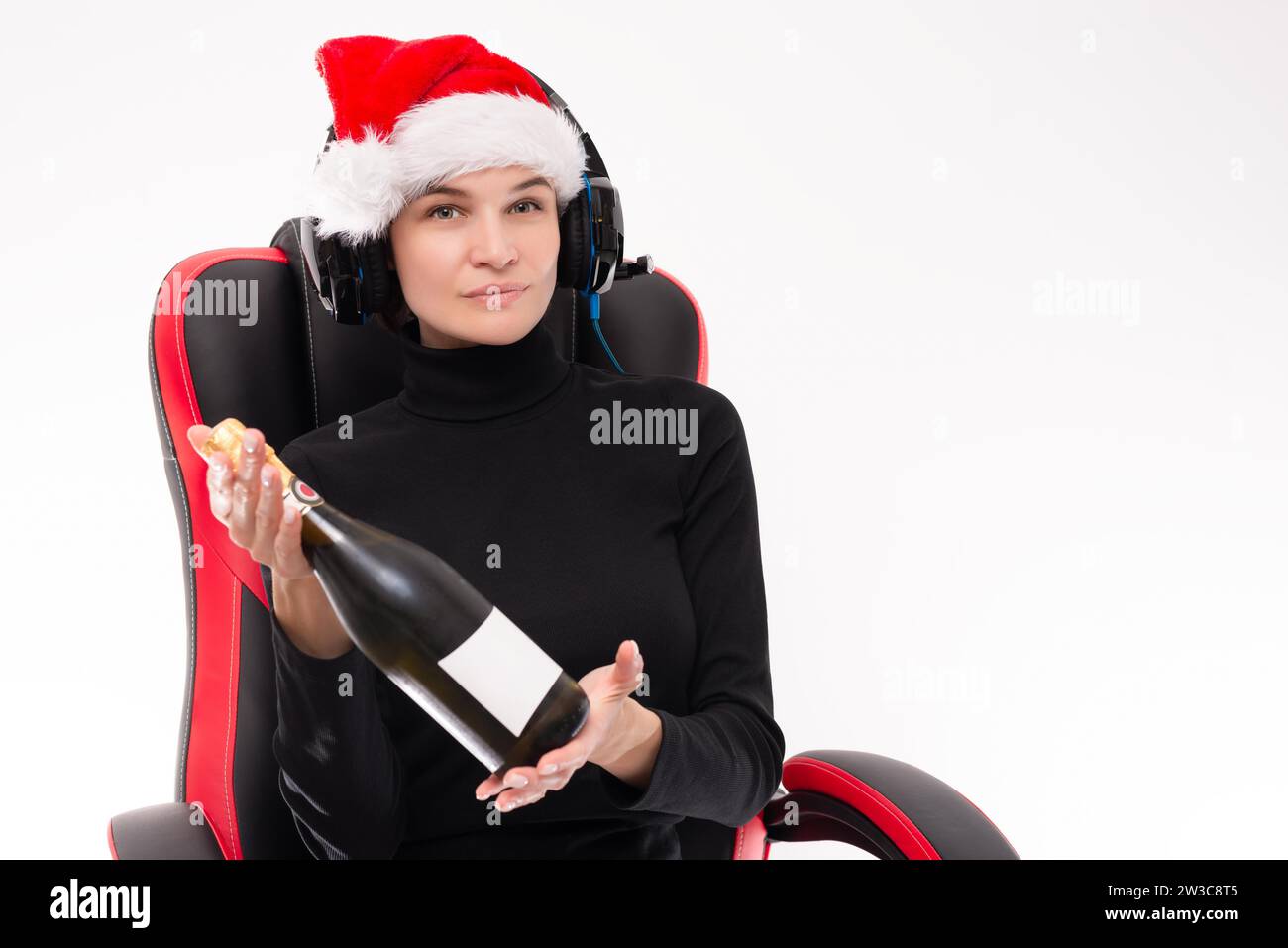 Image of a woman in a Santa Claus hat sitting in a gaming chair wearing ...