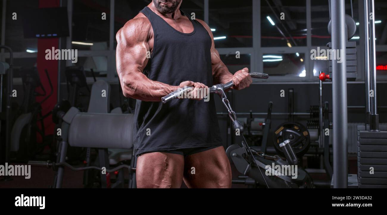 Image of a powerful athlete exercising in a crossover at the gym ...