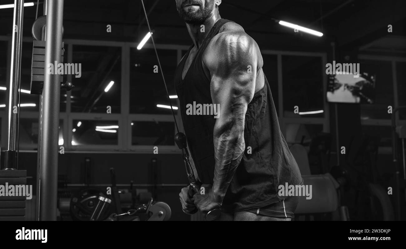 Image of a powerful athlete exercising in a crossover at the gym ...