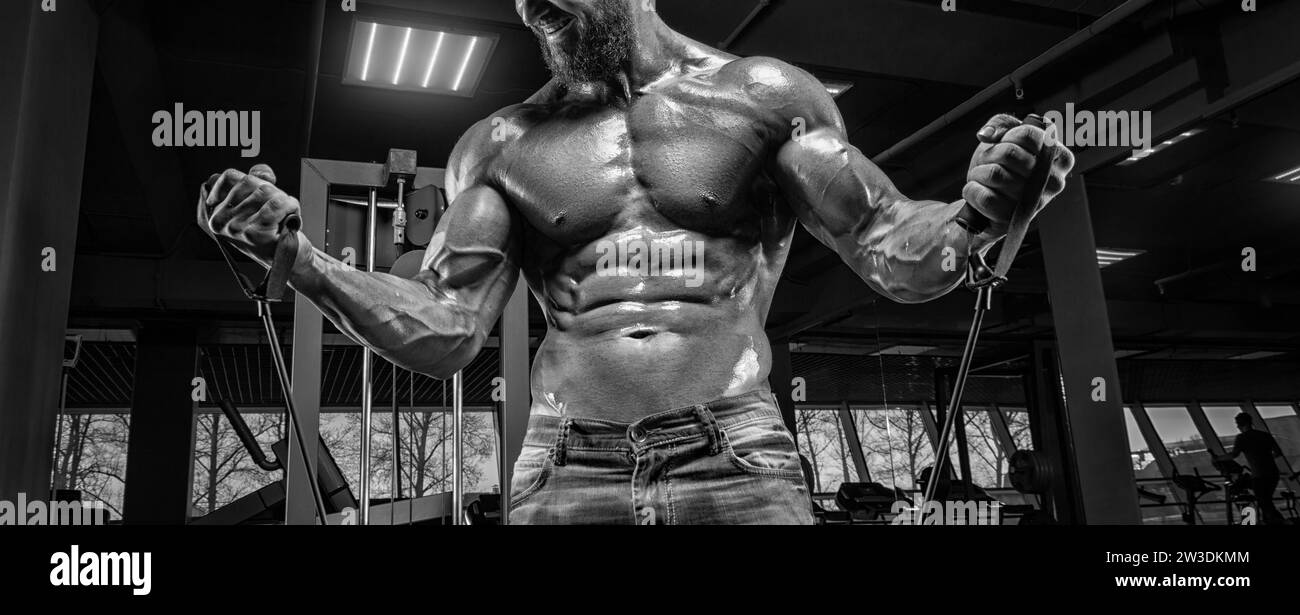 Professional athlete trains with elastic bands in the gym. Bodybuilding ...