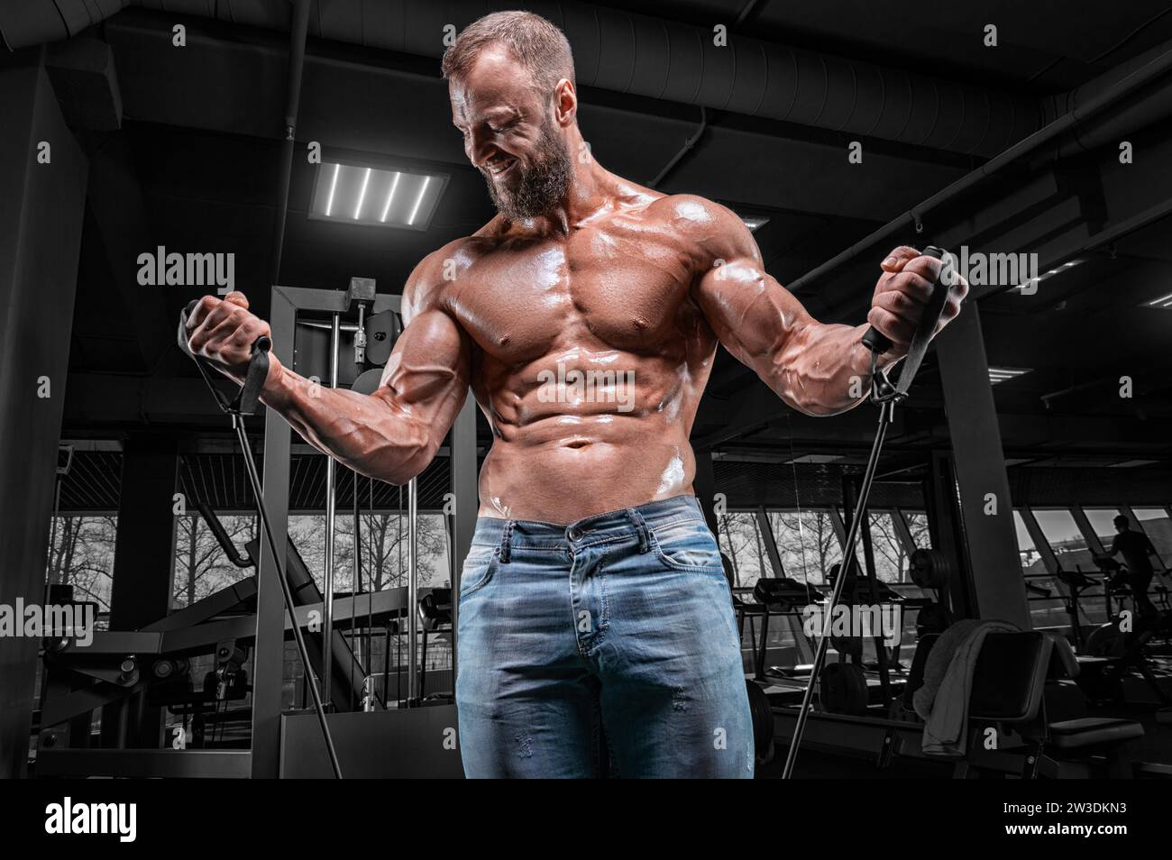 Professional athlete trains with elastic bands in the gym. Bodybuilding ...
