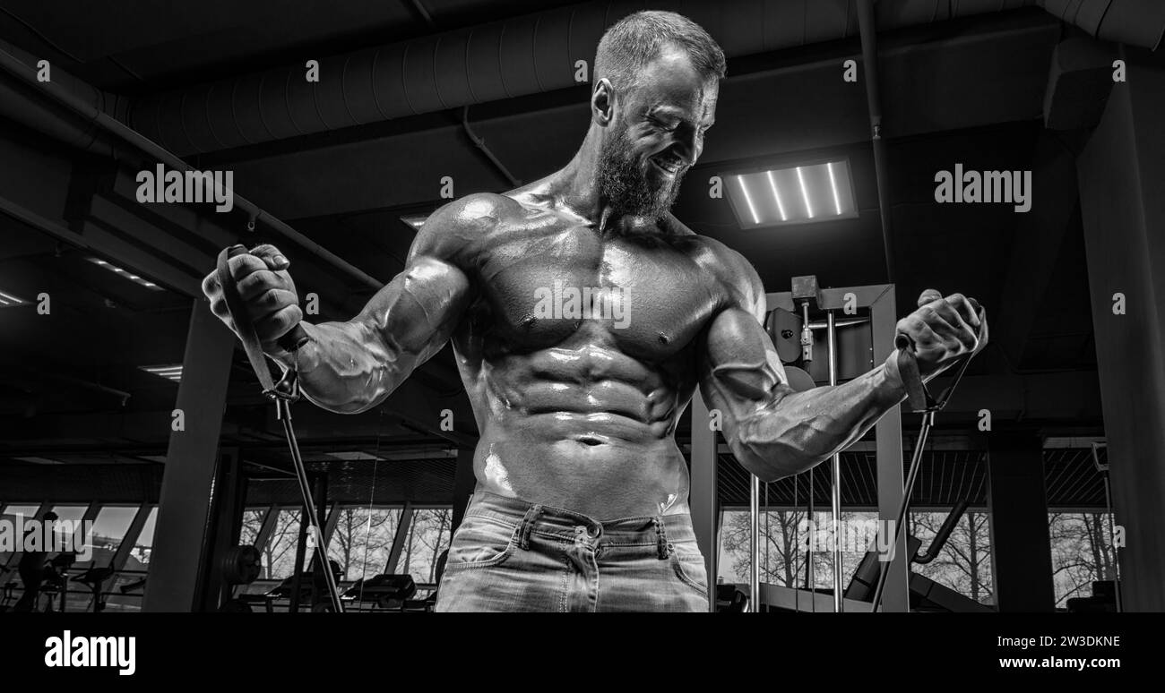 Professional athlete trains with elastic bands in the gym. Bodybuilding ...