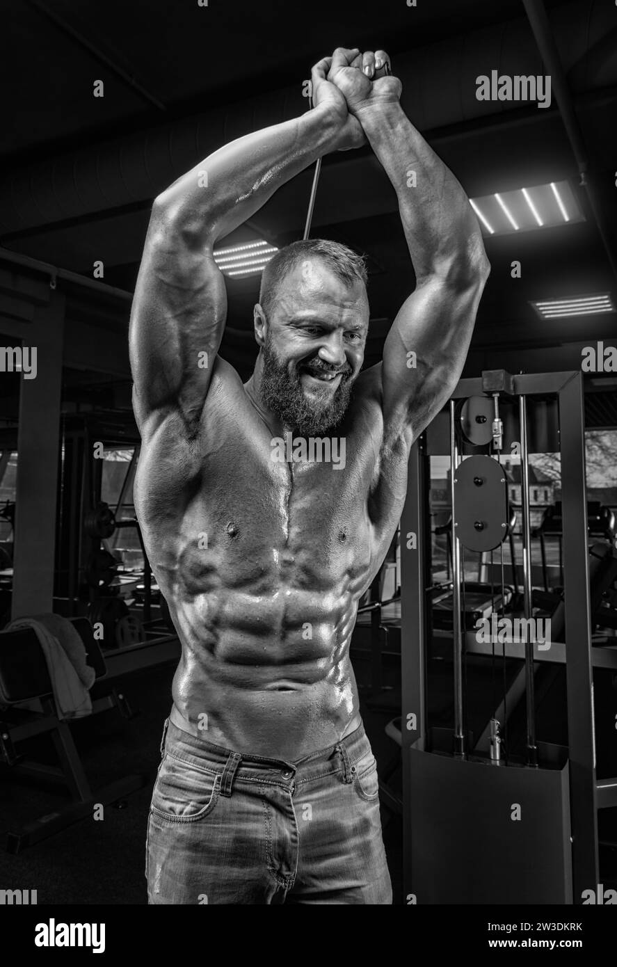 Professional athlete trains with elastic bands in the gym. Bodybuilding ...